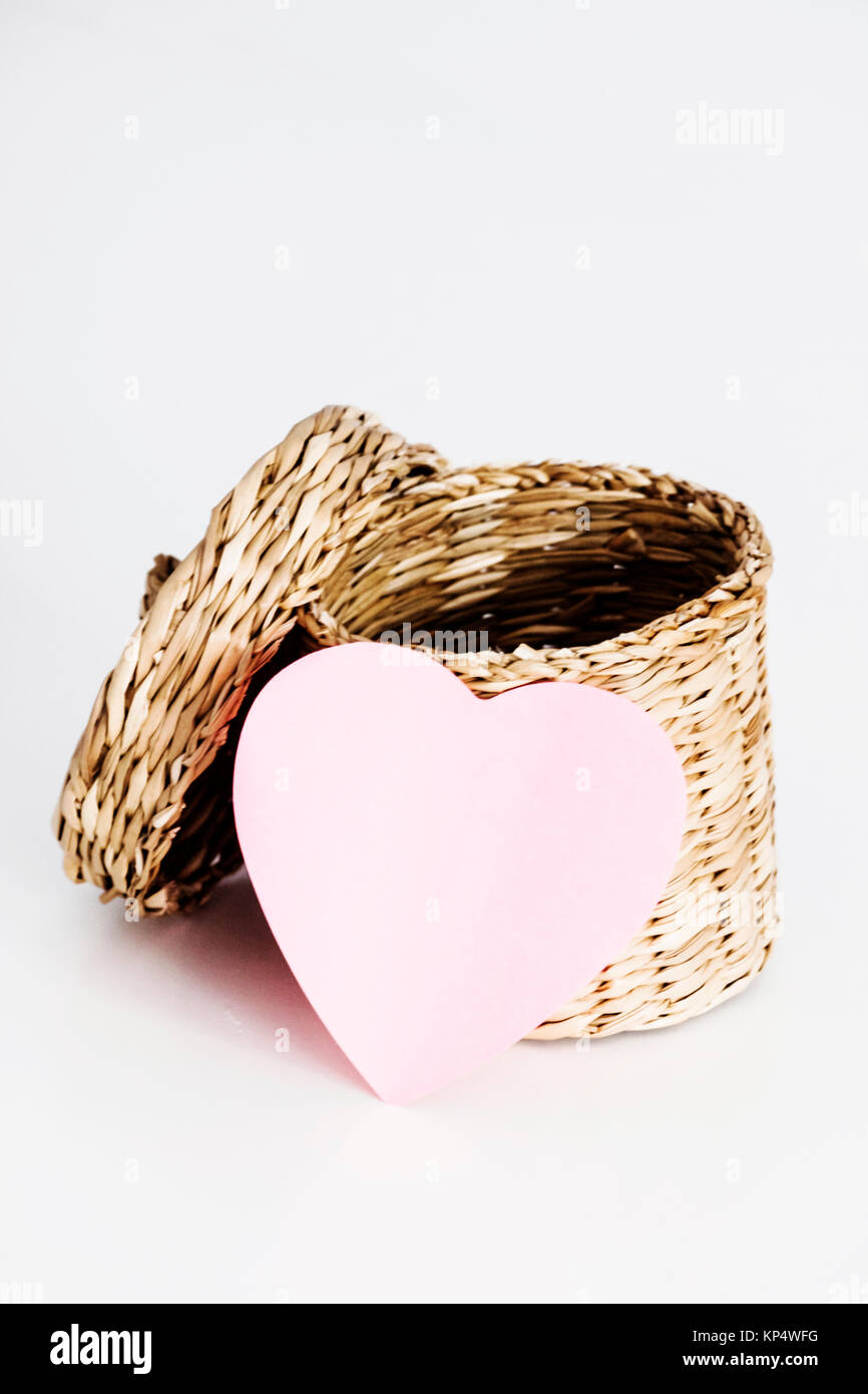 Empty straw basket with pink heart Stock Photo - Alamy