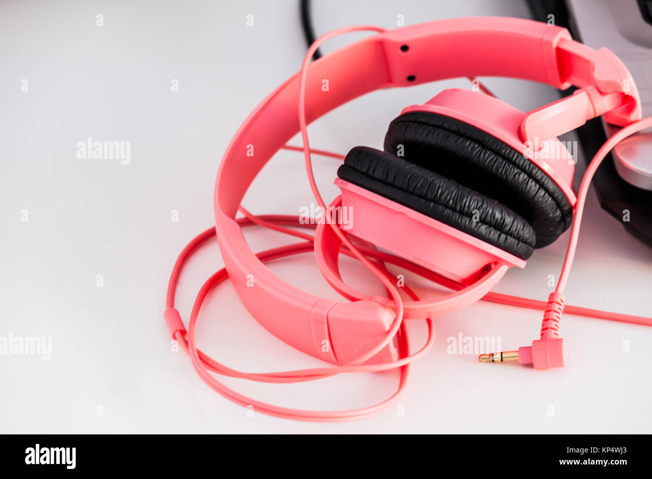 Pink headphones on the white computer desk Stock Photo - Alamy