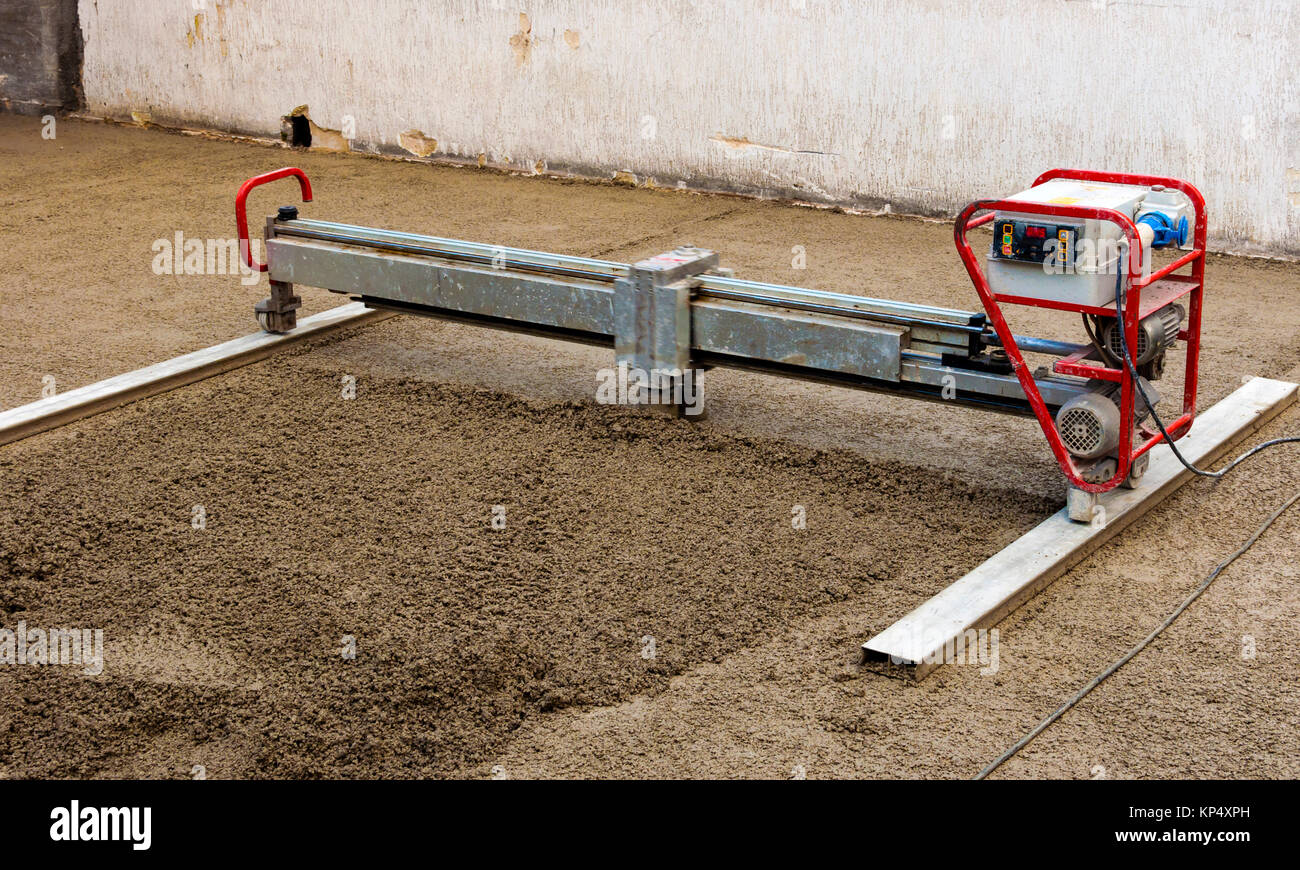 Construction site - machine running screed flooring Stock Photo - Alamy