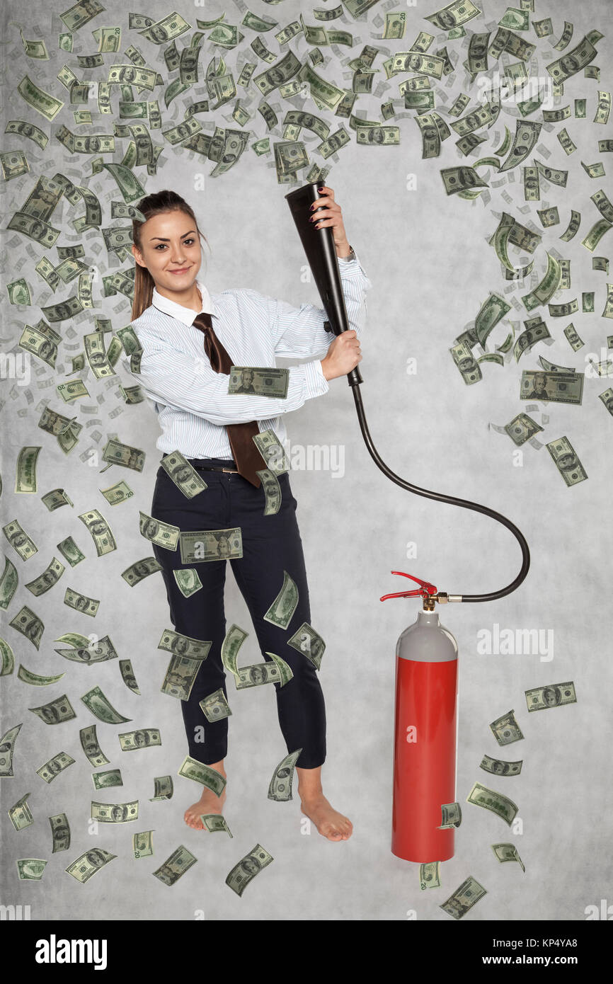 businesswoman under a rain of money from a fire extinguisher Stock ...