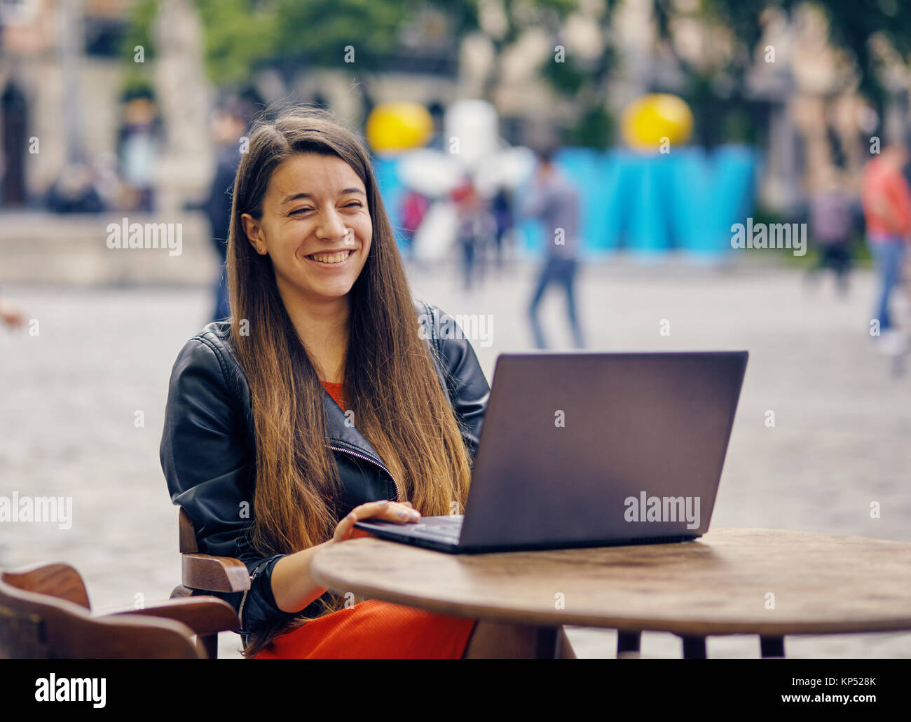 young woman sit down on wood table working on computer Stock Photo - Alamy