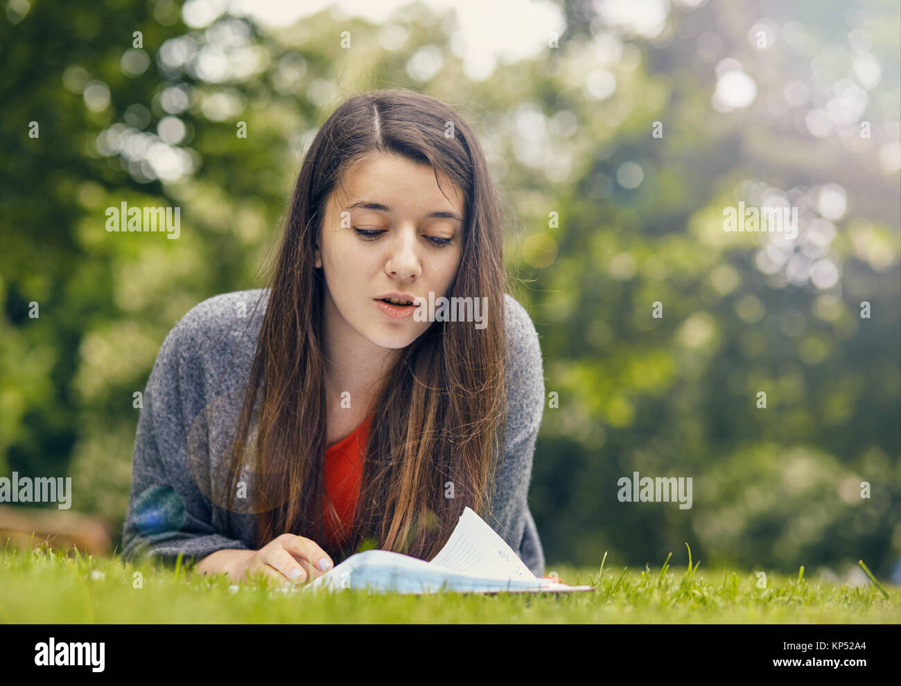 Beautiful woman reading book in nature Stock Photo - Alamy