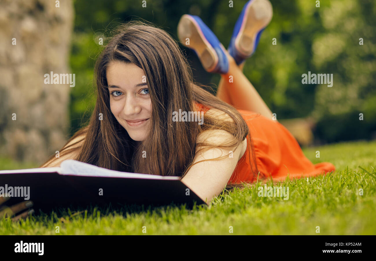Beautiful woman reading book in nature Stock Photo - Alamy