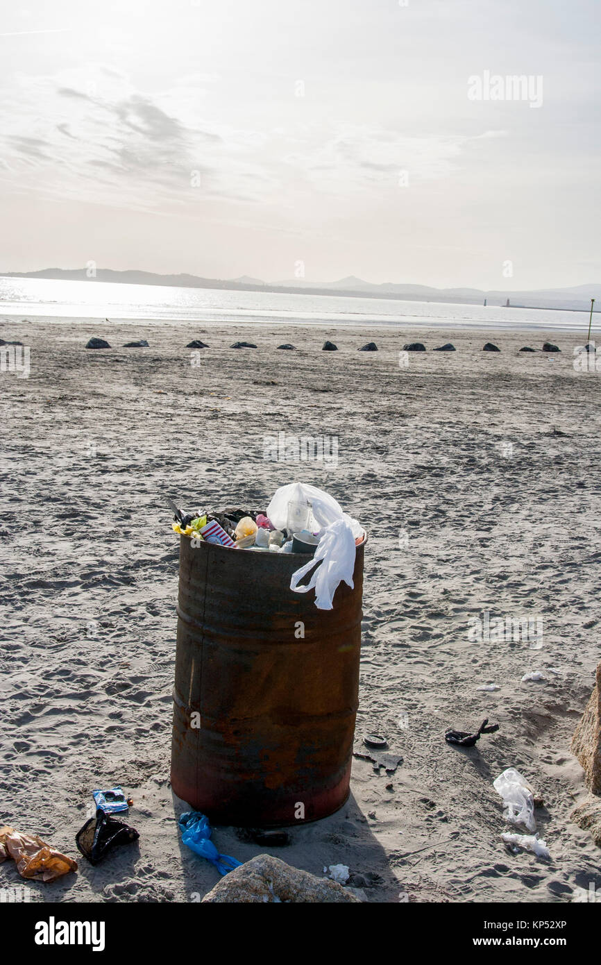 Overflowing rusty bin full of rubbish, waste on the beach, Dollymount ...