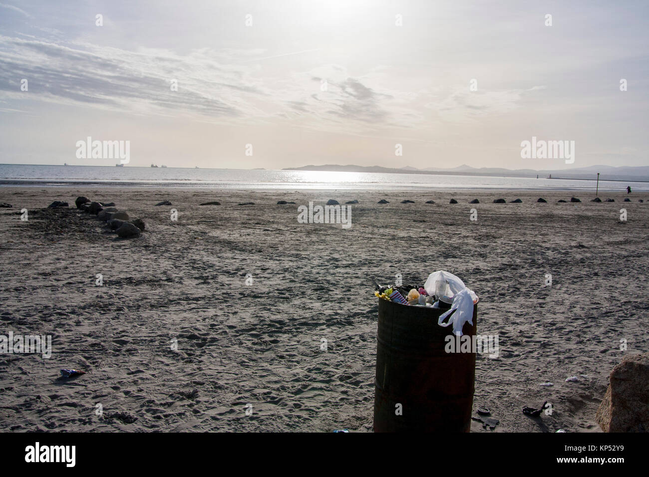 Overflowing rusty bin full of rubbish, litter bin waste on the beach ...