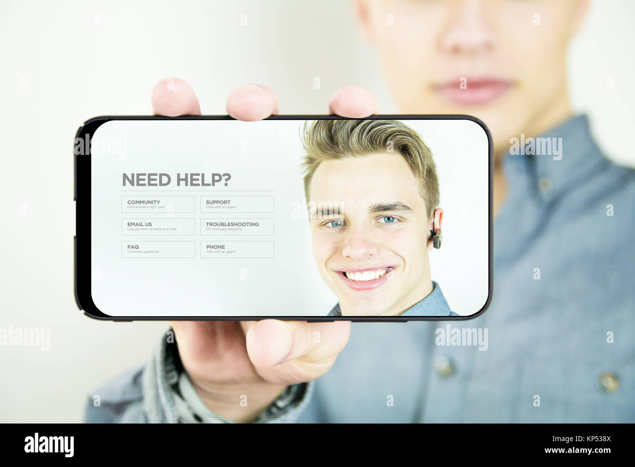 young man holding and showing a customer support website on full screen ...