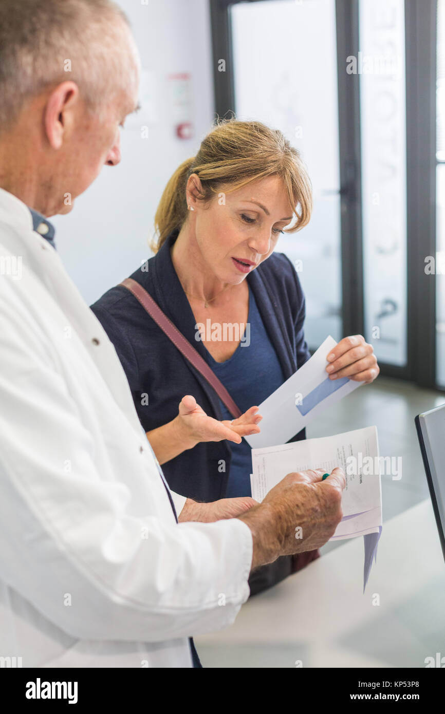Reception desk of medical center Stock Photo - Alamy