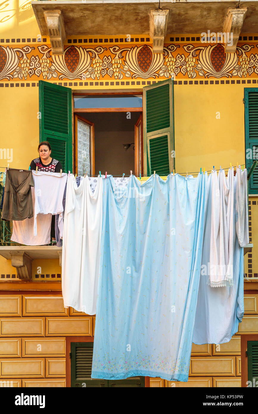 A lady hanging out laundry to dry in the village of Corniglia, Cinque ...