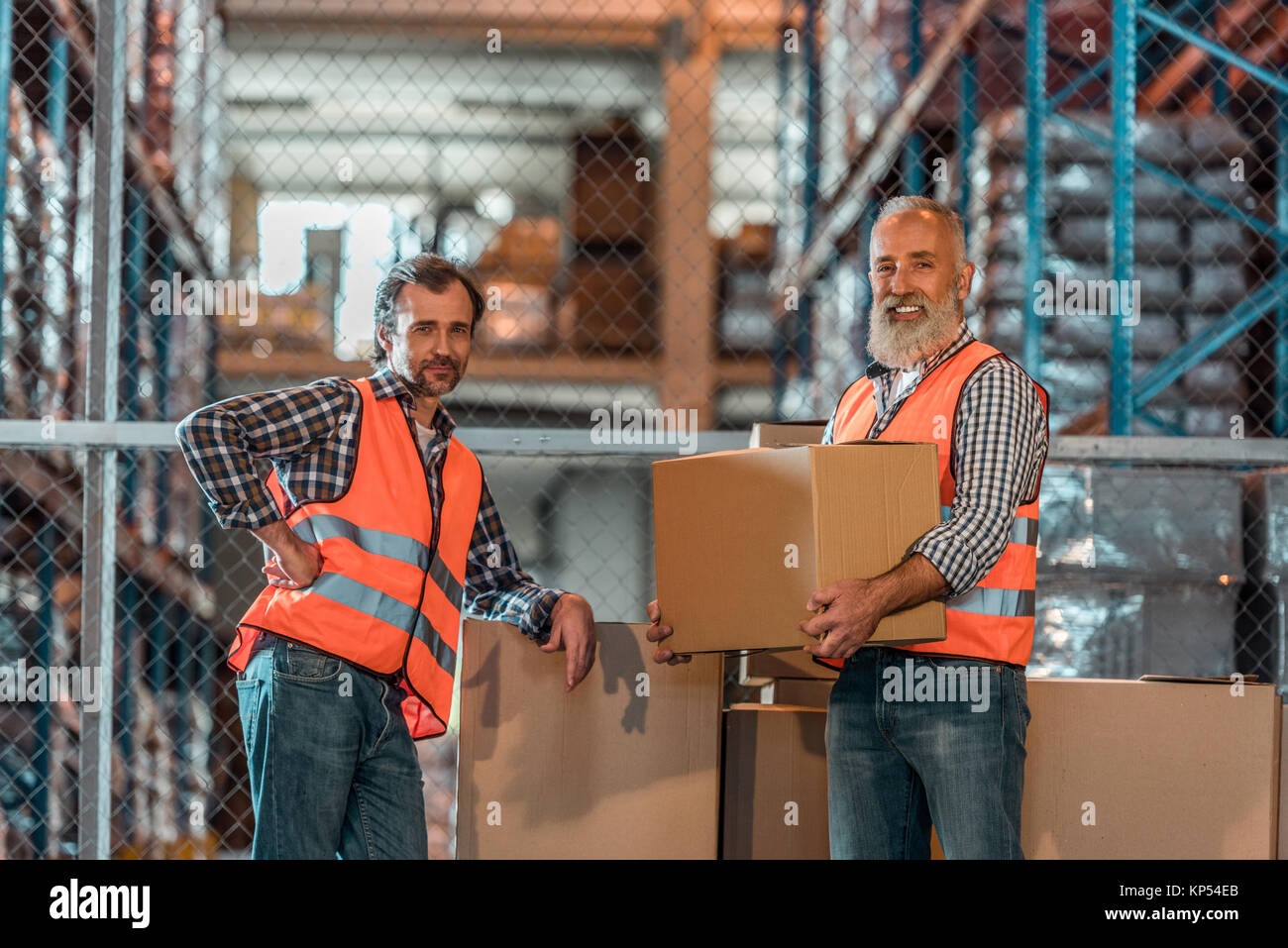 warehouse workers with boxes Stock Photo - Alamy