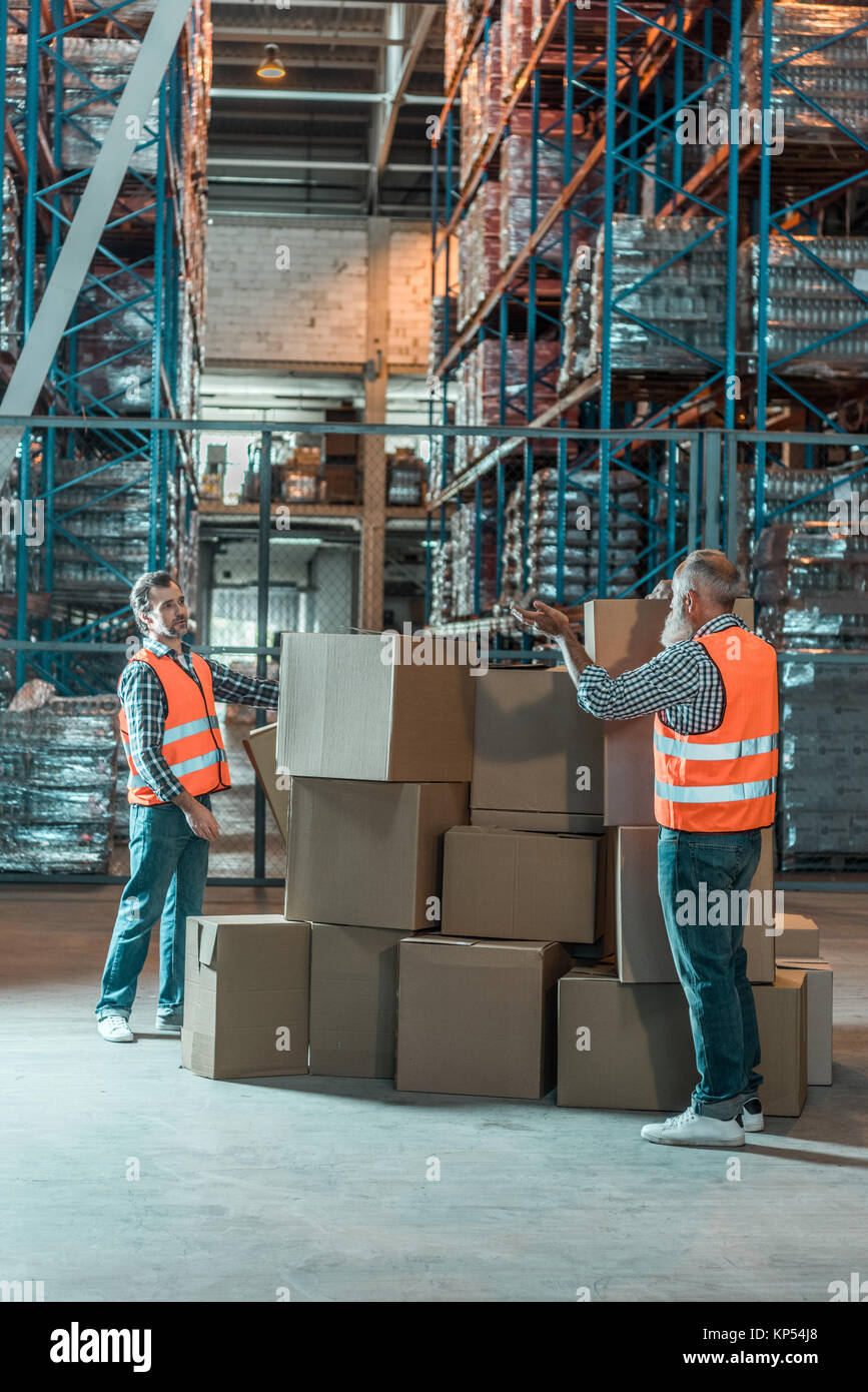 warehouse workers with boxes Stock Photo - Alamy