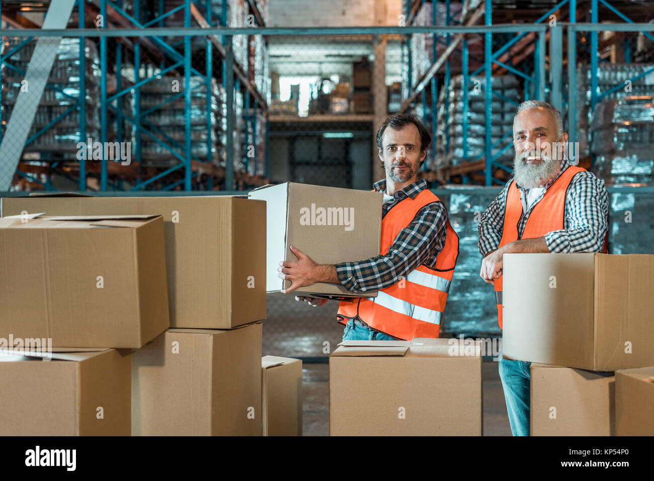 warehouse workers with boxes Stock Photo - Alamy