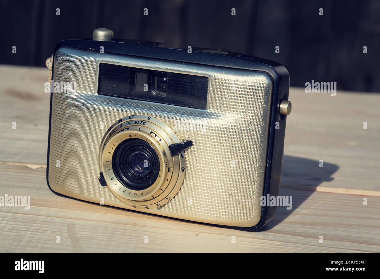 Old vintage golden Penti I camera on wooden background Stock Photo - Alamy