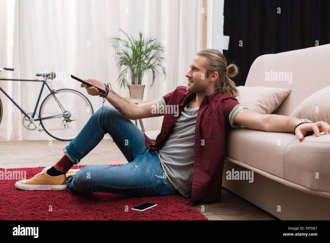 handsome man with remote control watching tv at home Stock Photo - Alamy
