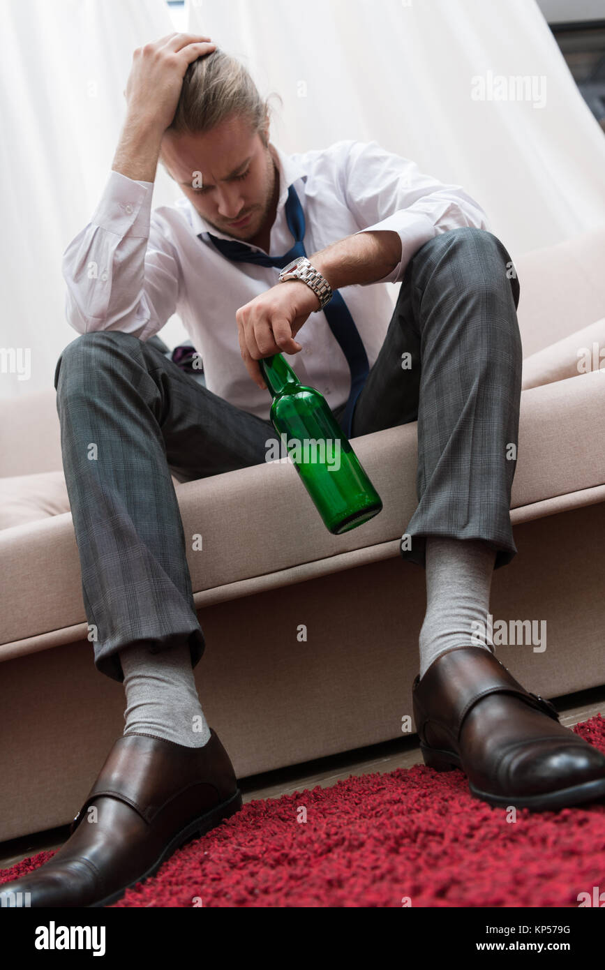 Man having headache after drinking alcohol Stock Photo - Alamy