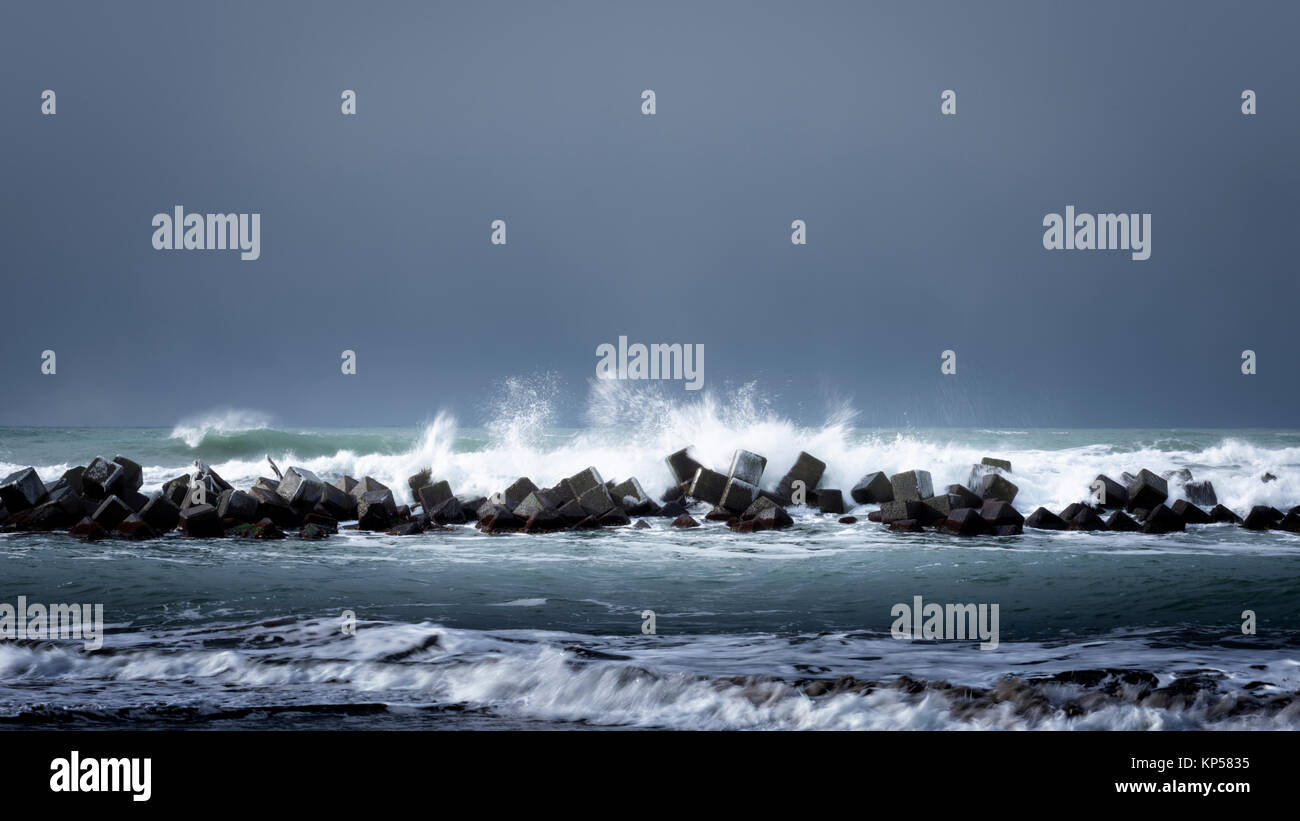 Winter storm waves from the Sea of Japan crashing over wave breakers on ...