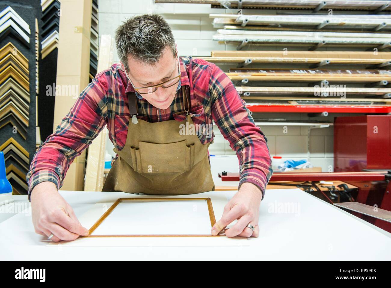 Goirle, Netherlands. Mid adult male craftsman and picture framemaker ...