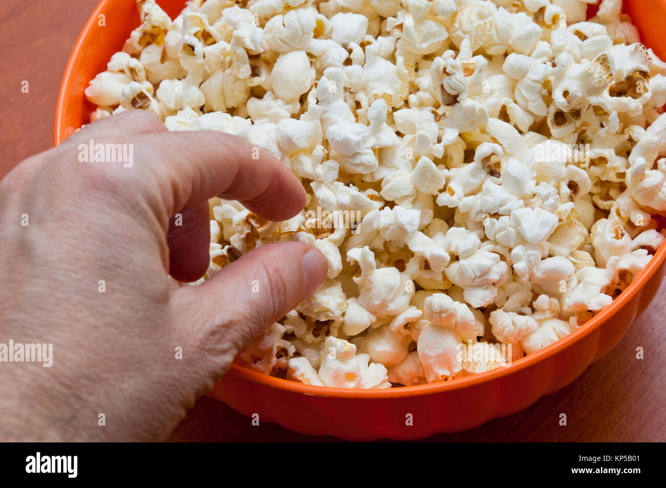 hand picking up popcorn from a bowl Stock Photo - Alamy