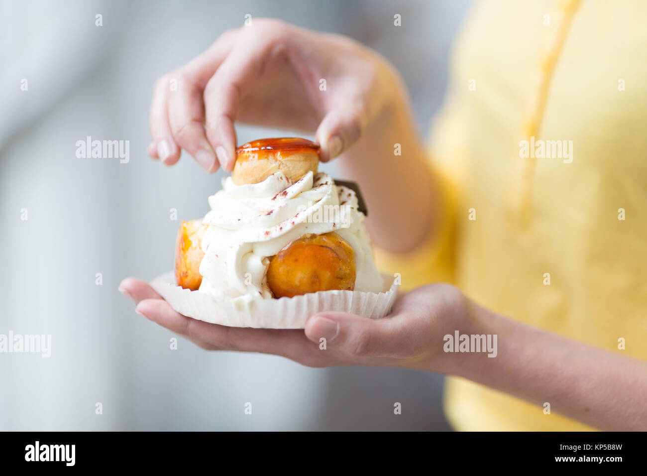 Woman eating pastry Stock Photo - Alamy