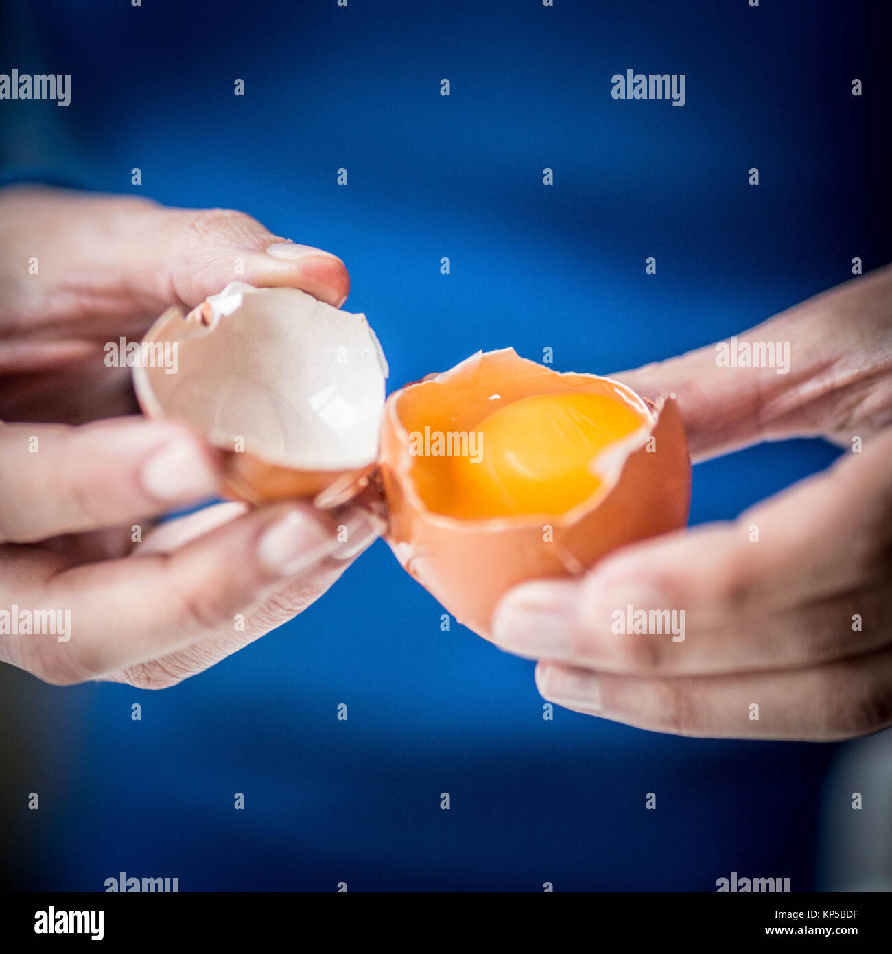 Woman breaking an egg Stock Photo - Alamy