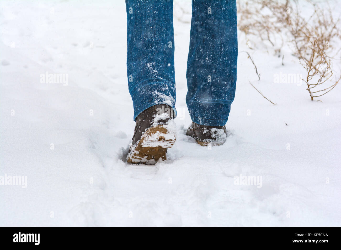 A person walks through deep snow Stock Photo - Alamy