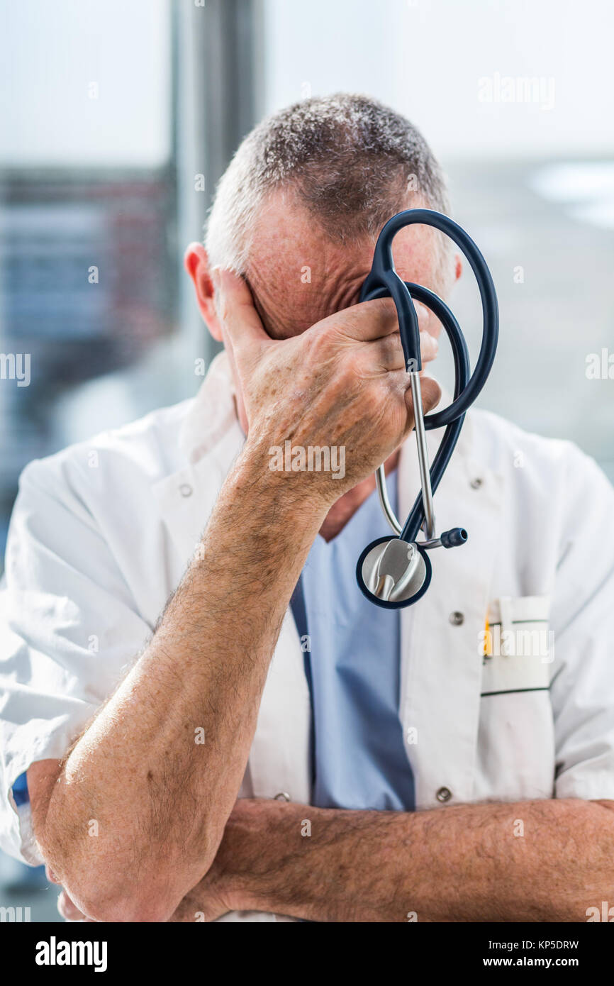 Doctor looking tired Stock Photo - Alamy