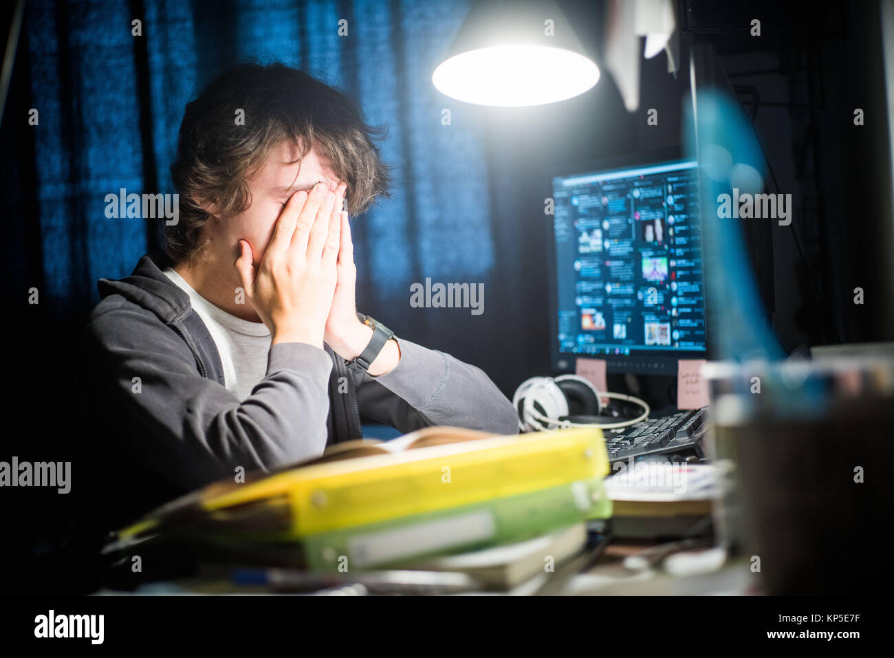 Teenager doing his homework in front of a computer Stock Photo - Alamy