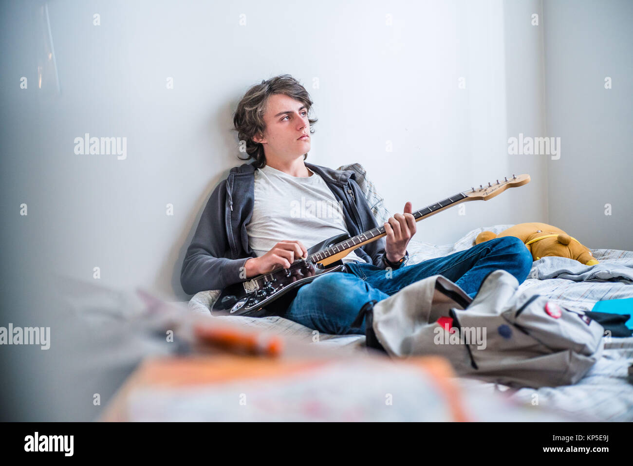 Teenage boy playing electric guitar Stock Photo - Alamy