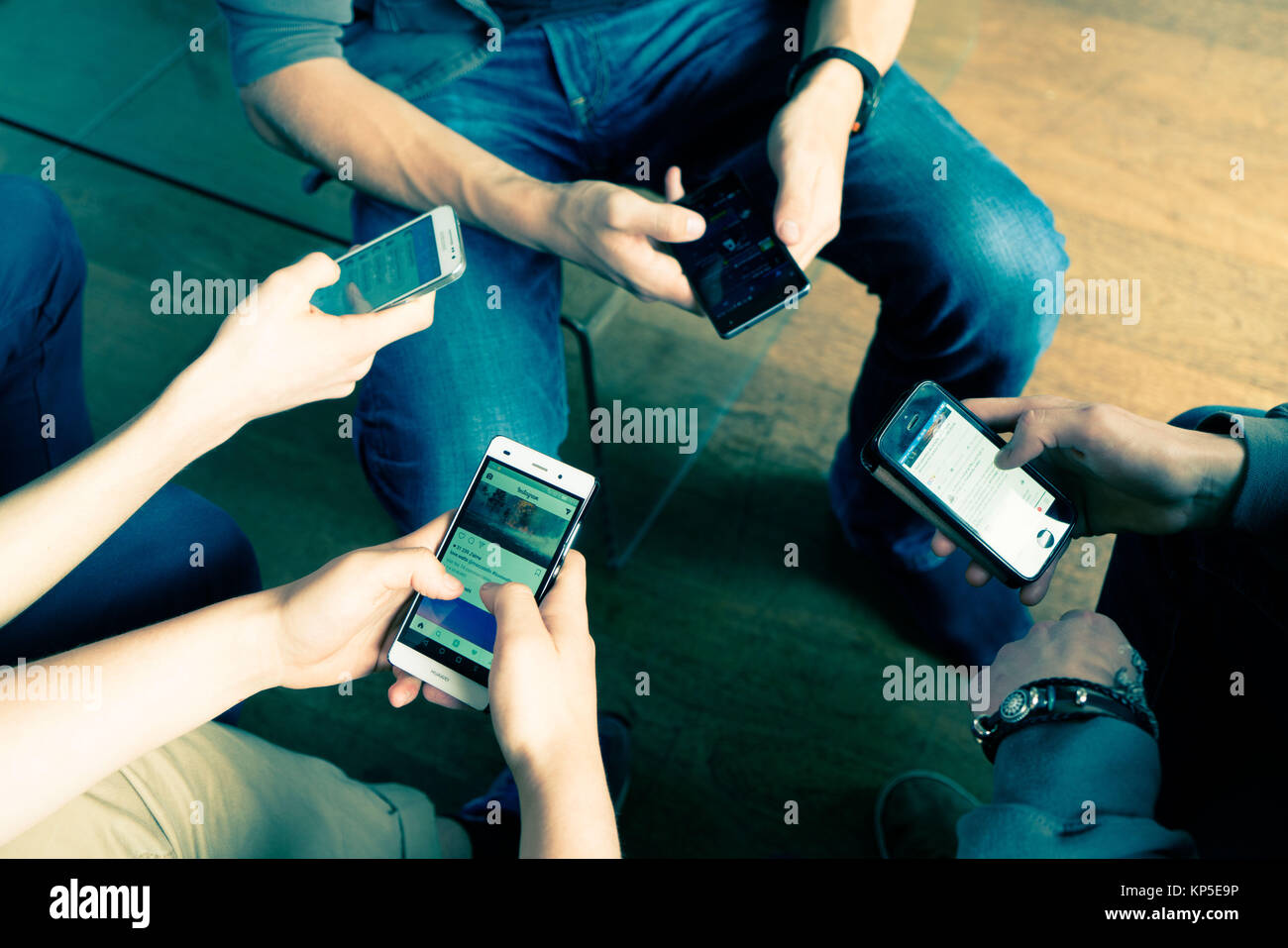 Group of teenagers using smartphones Stock Photo - Alamy