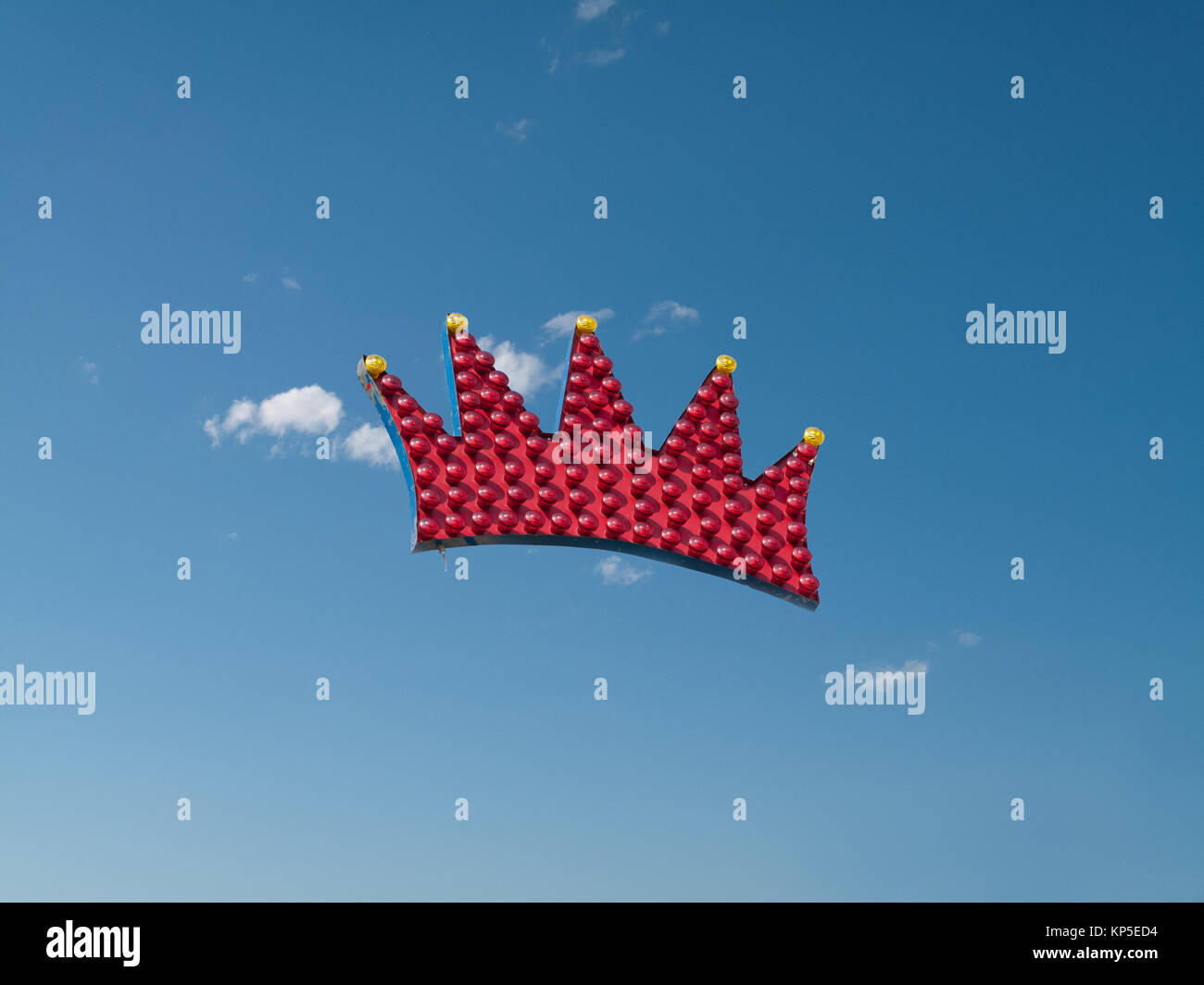 flying crown neon sign in the blue sky Stock Photo - Alamy