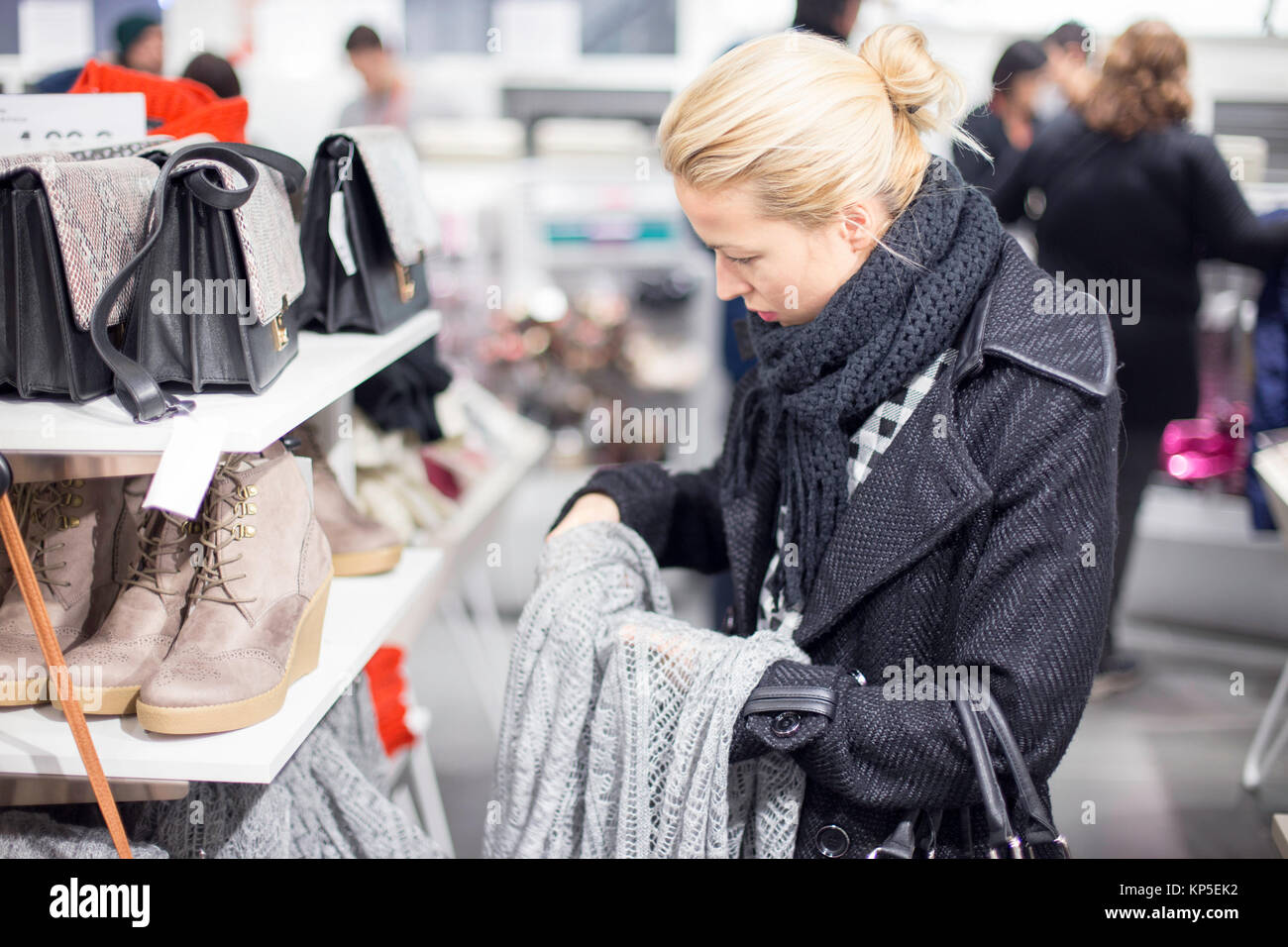 Beautiful woman shopping in clothing store Stock Photo - Alamy