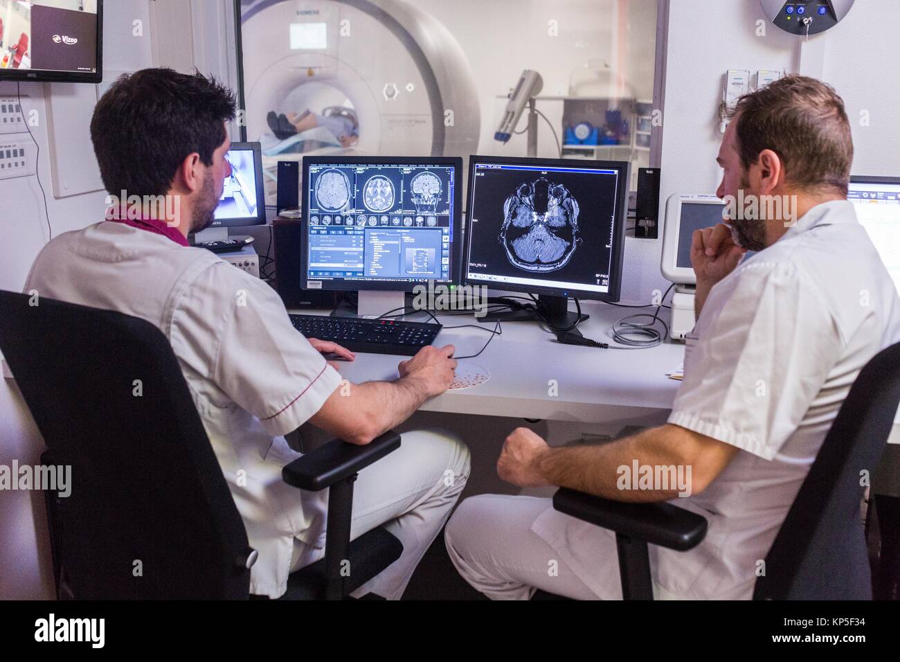 Patient in an MRI (magnetic resonance imaging) scanner, MRI of the ...
