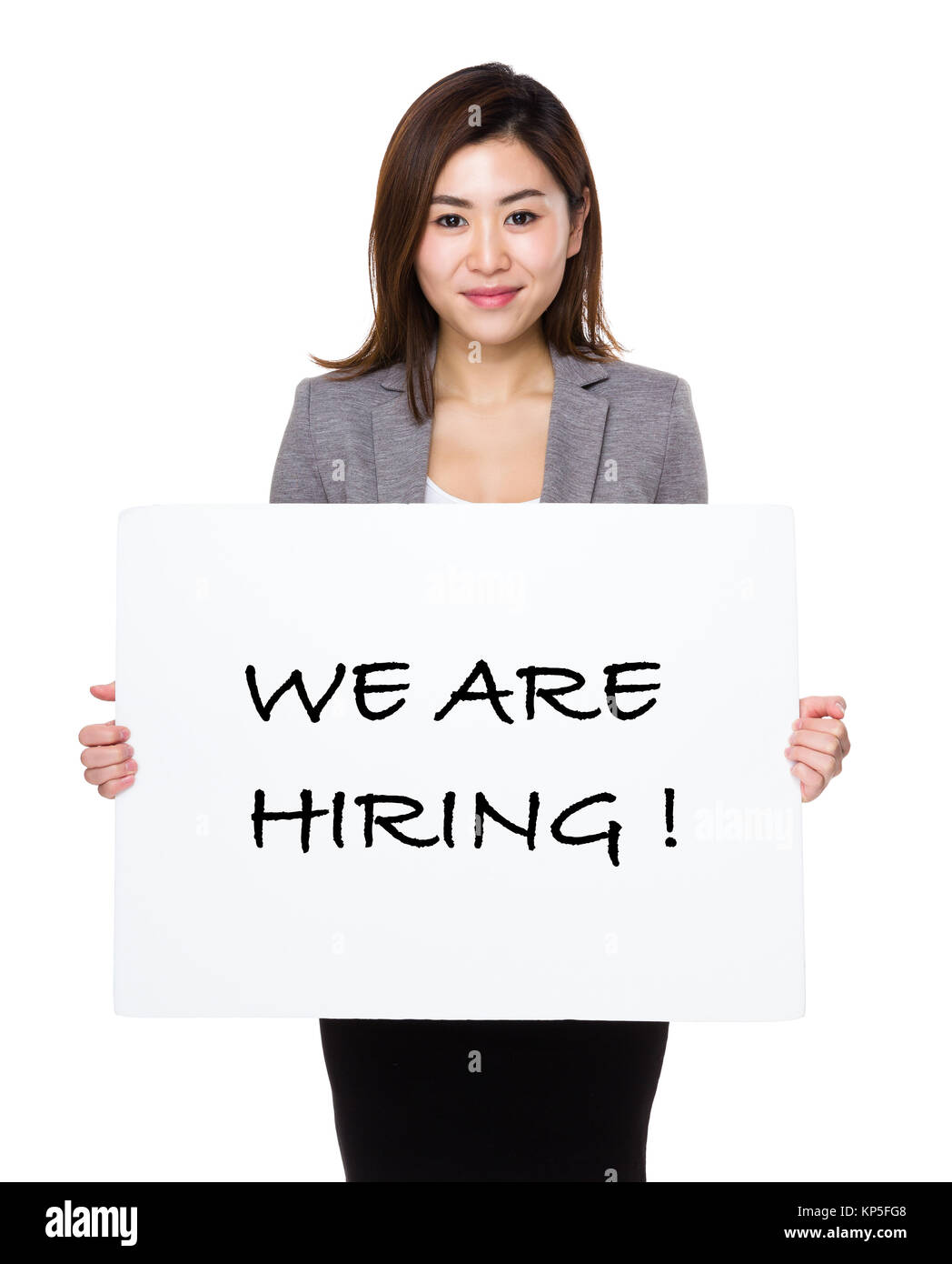 Young businesswoman holding a poster showing with we are hiring phrases ...