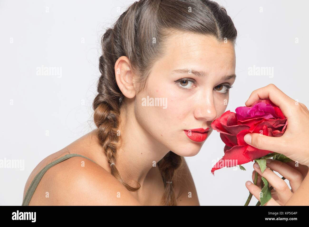 Close up of mid-adult woman smelling rose Stock Photo - Alamy