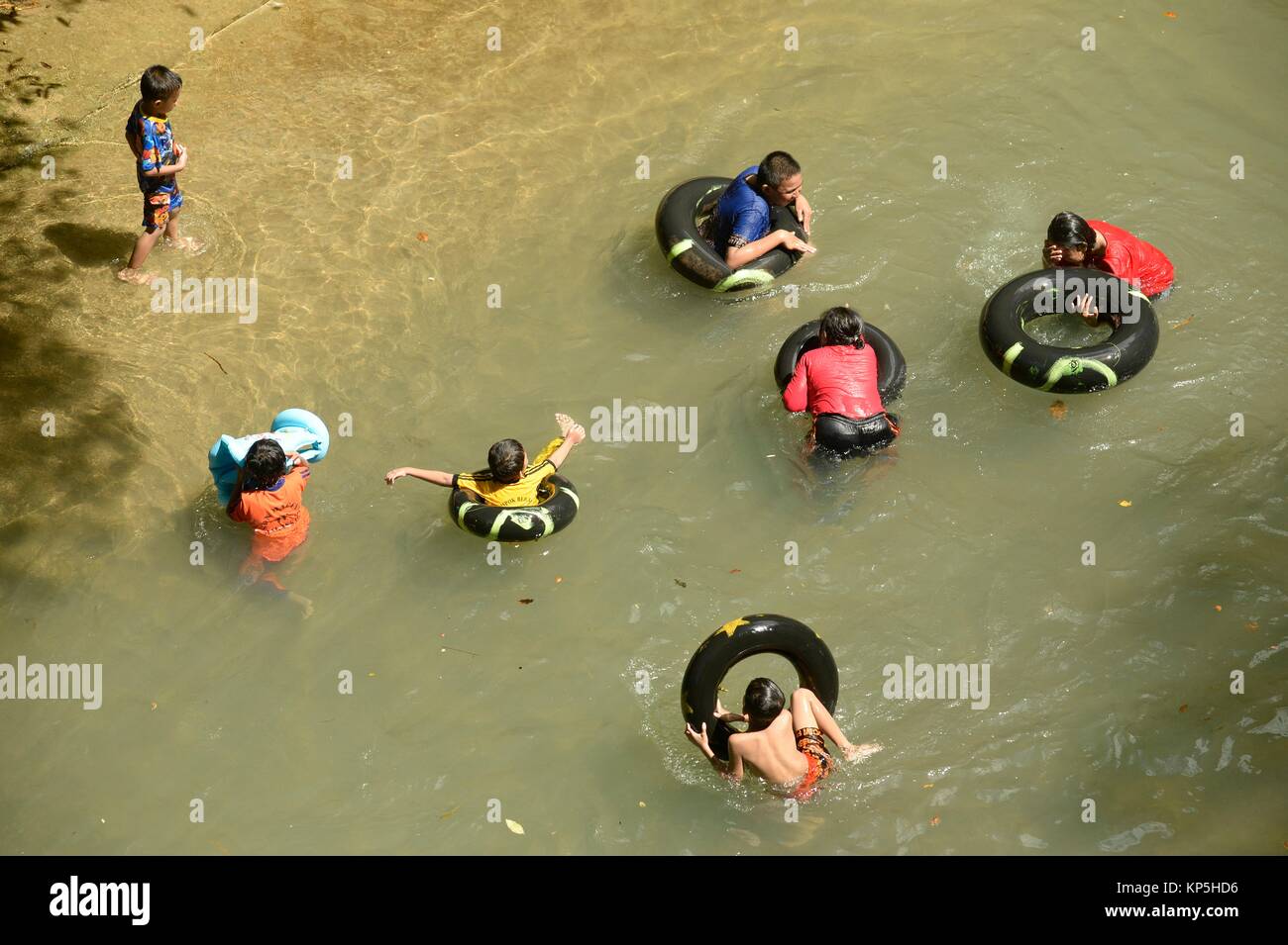 Children floating in the water using tyre swim float,Bantimurung water ...