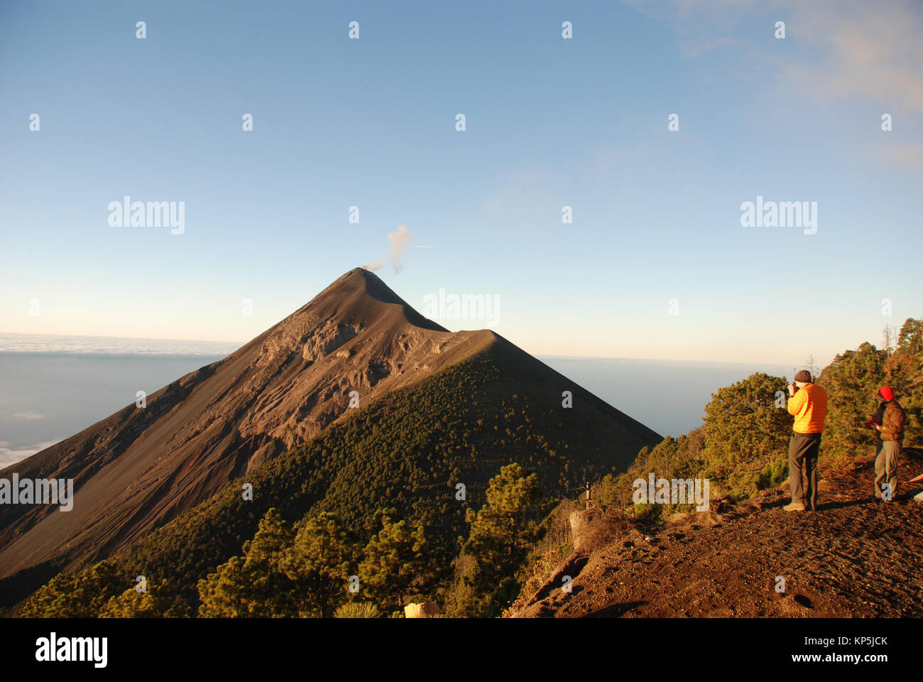 trekkers watch an eruption of Fuego volcano from a high camp on ...