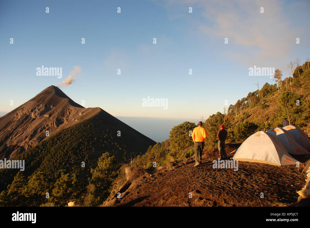 trekkers watch an eruption of Fuego volcano from a high camp on ...