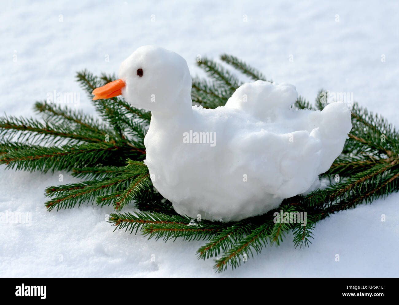 Christmas goose made of snow sitting on a fir branch, sunlight Stock ...