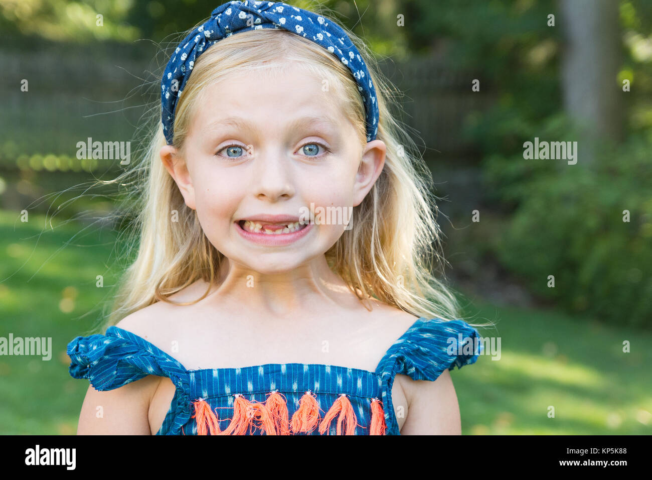 adorable school age girl showing missing front two baby teeth Stock ...