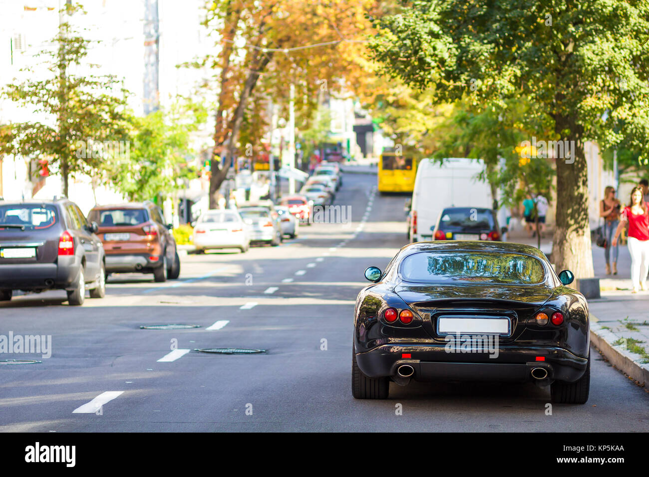 Modern new car on the side of the street. Rows of cars parked on the ...