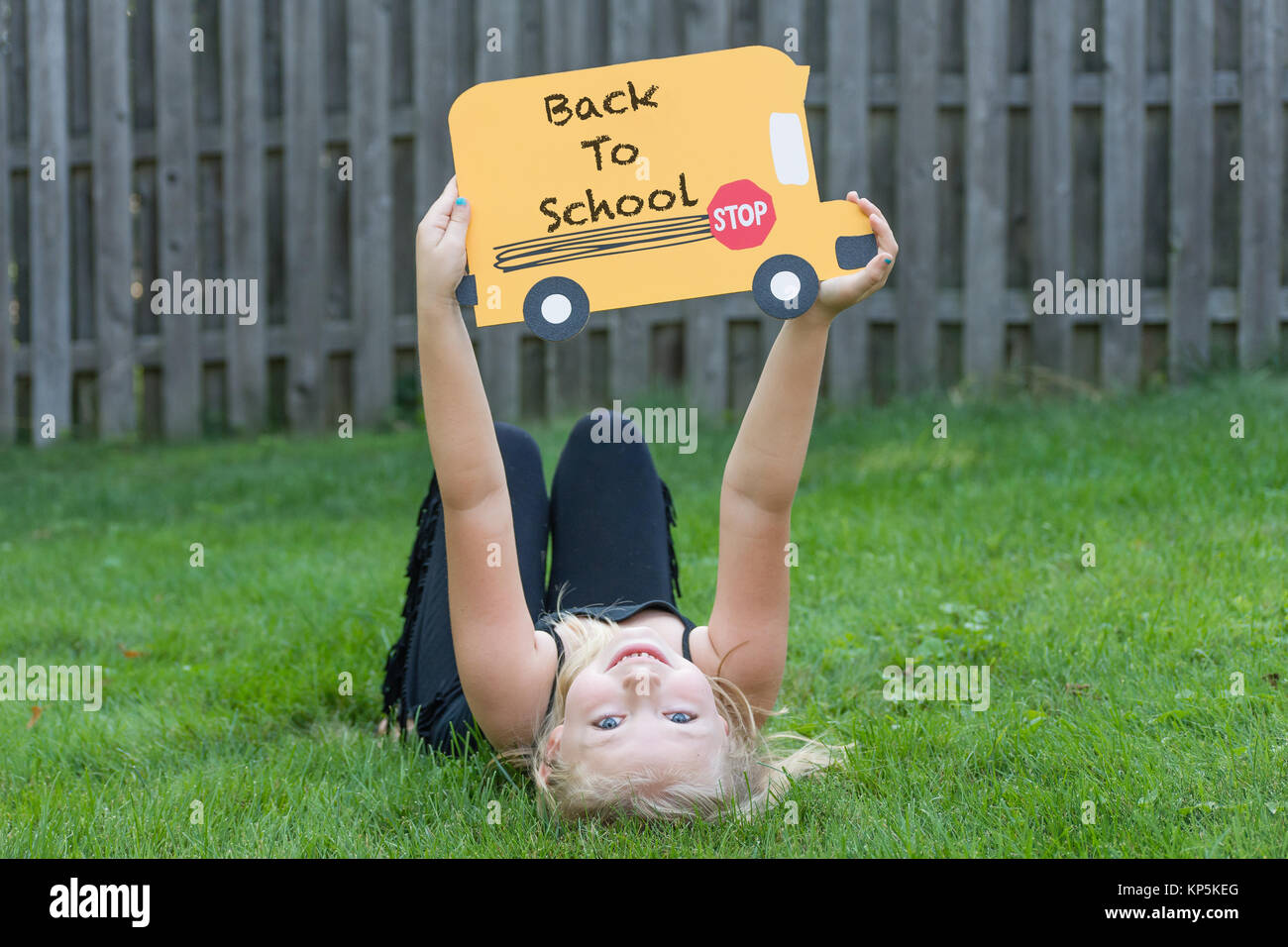 adorable school age girl holding back to school sign for first day of ...