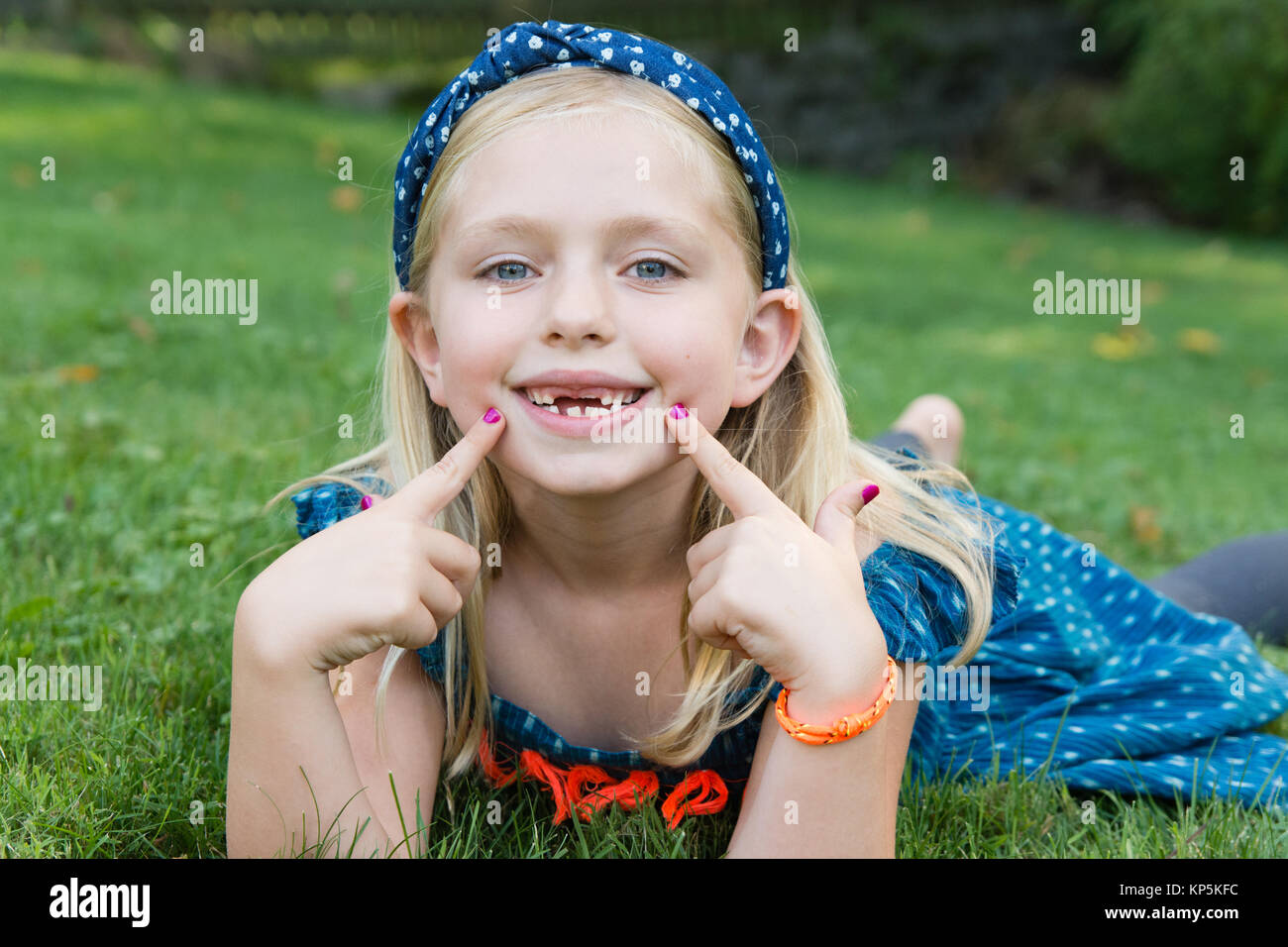 adorable school age girl showing off missing front two baby teeth Stock ...