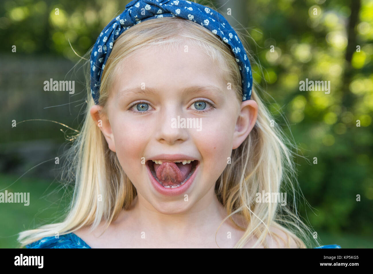 adorable school age girl showing off missing front two baby teeth Stock ...