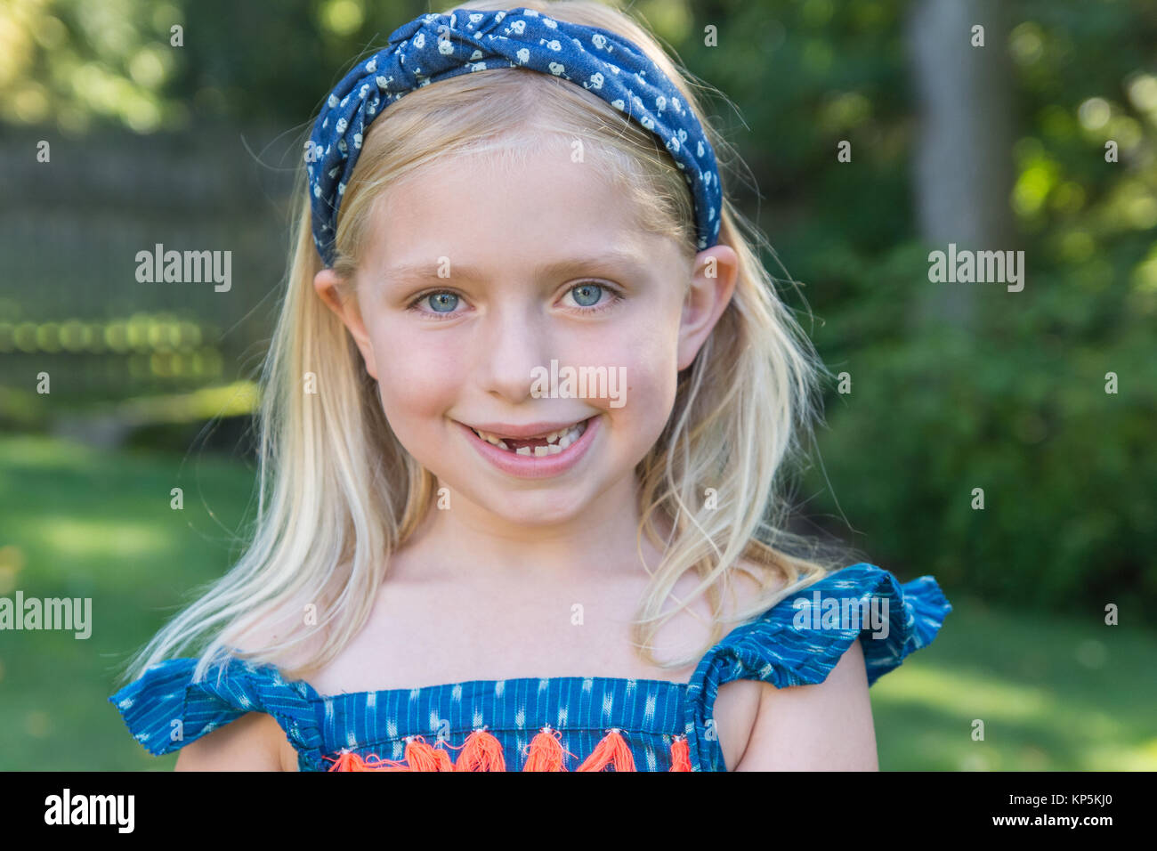 adorable school age girl showing off missing front two baby teeth Stock ...