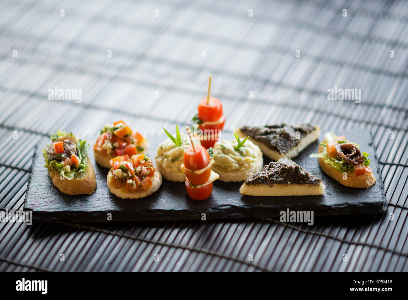 mixed international fusion tapas platter with tapenade, anchovies, fish ...