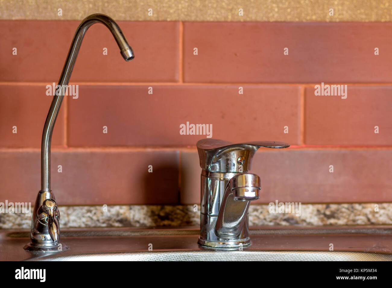 New shiny metal water faucet in modern kitchen Stock Photo - Alamy