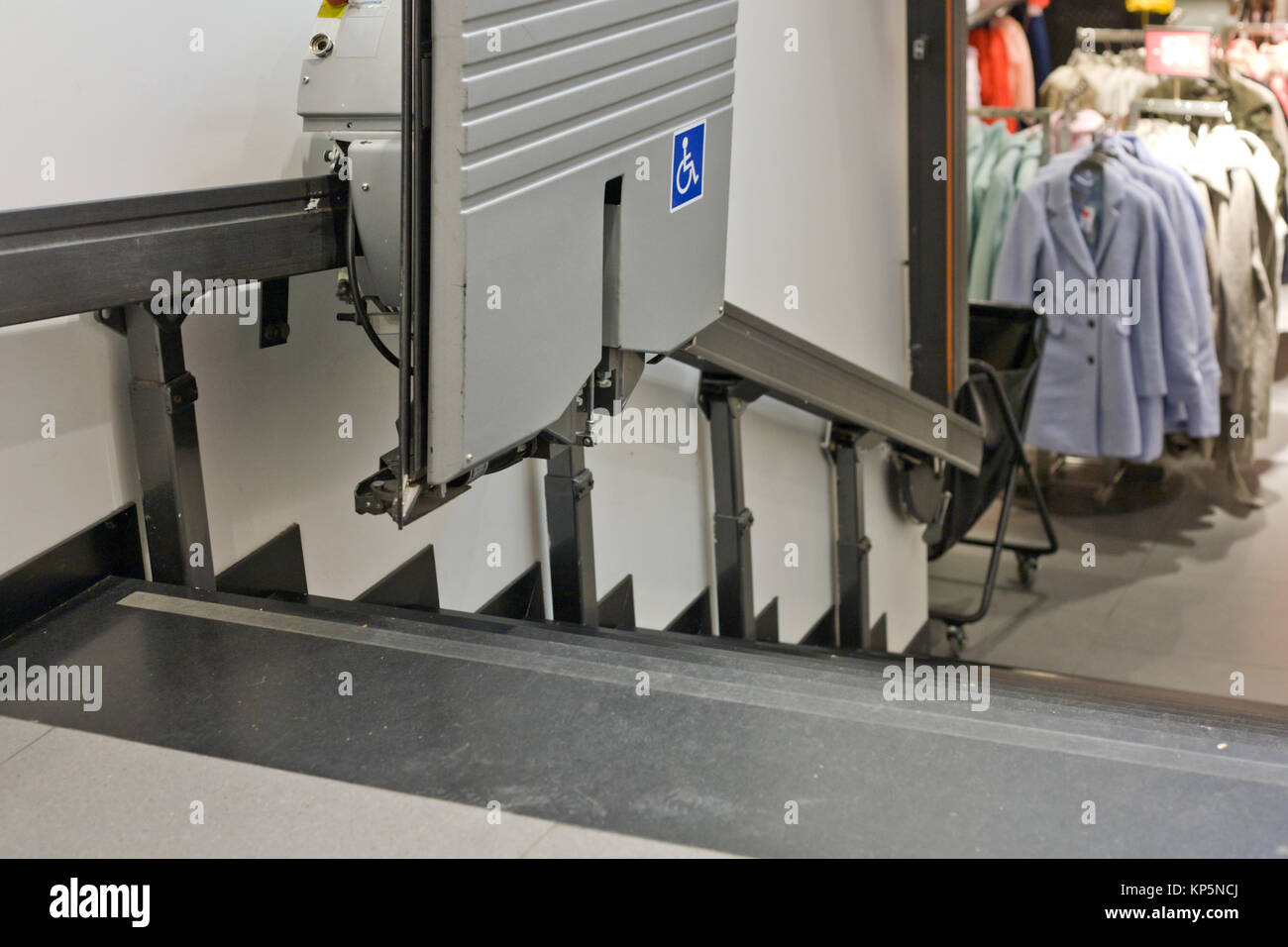 Clothing store chair lift Stock Photo - Alamy