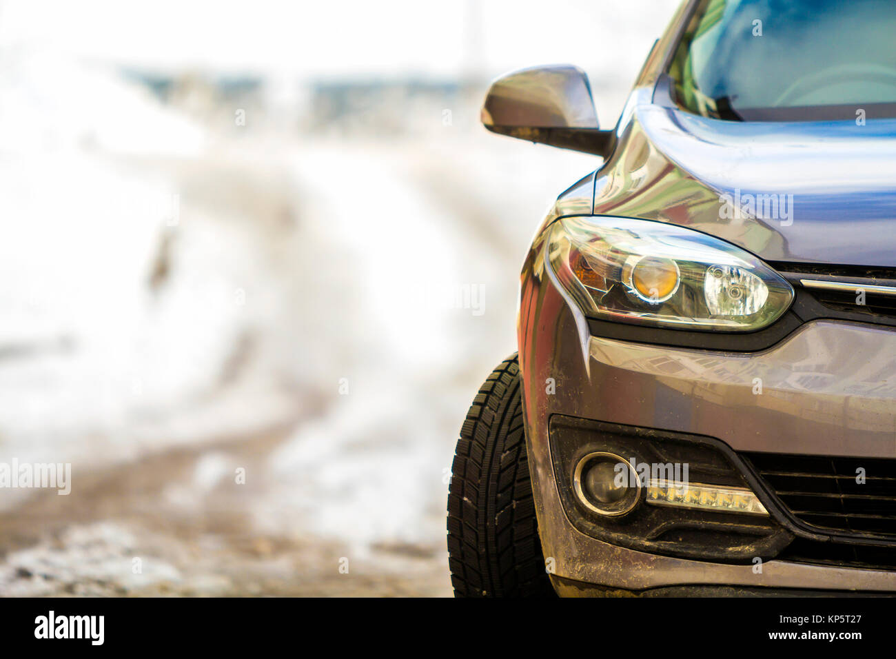 New modern grey car parked on a street in winter Stock Photo - Alamy