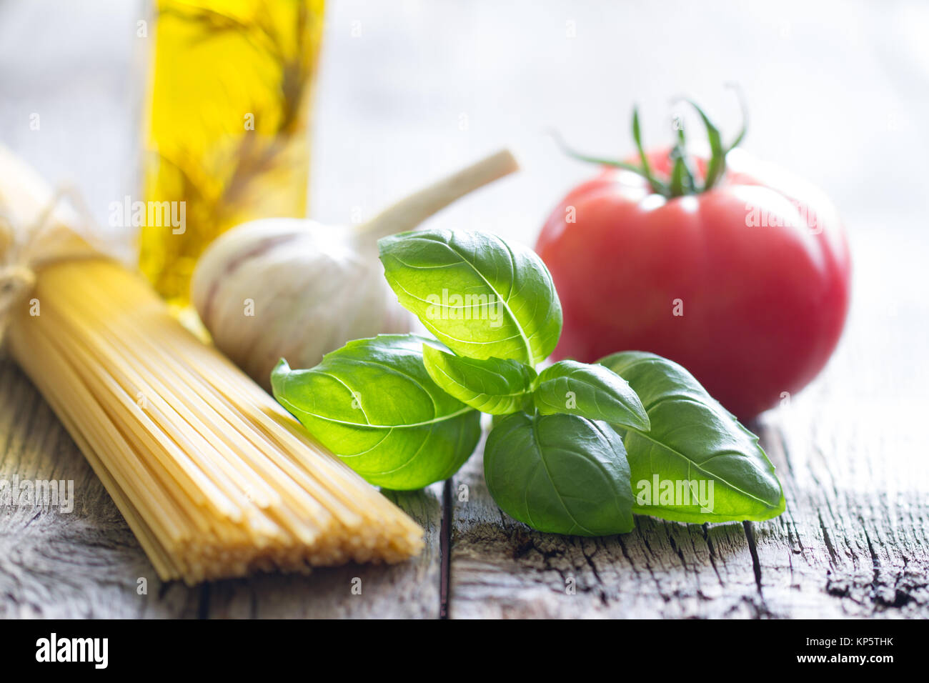 Basil tomato and garlic italian food still life with pasta on retro ...