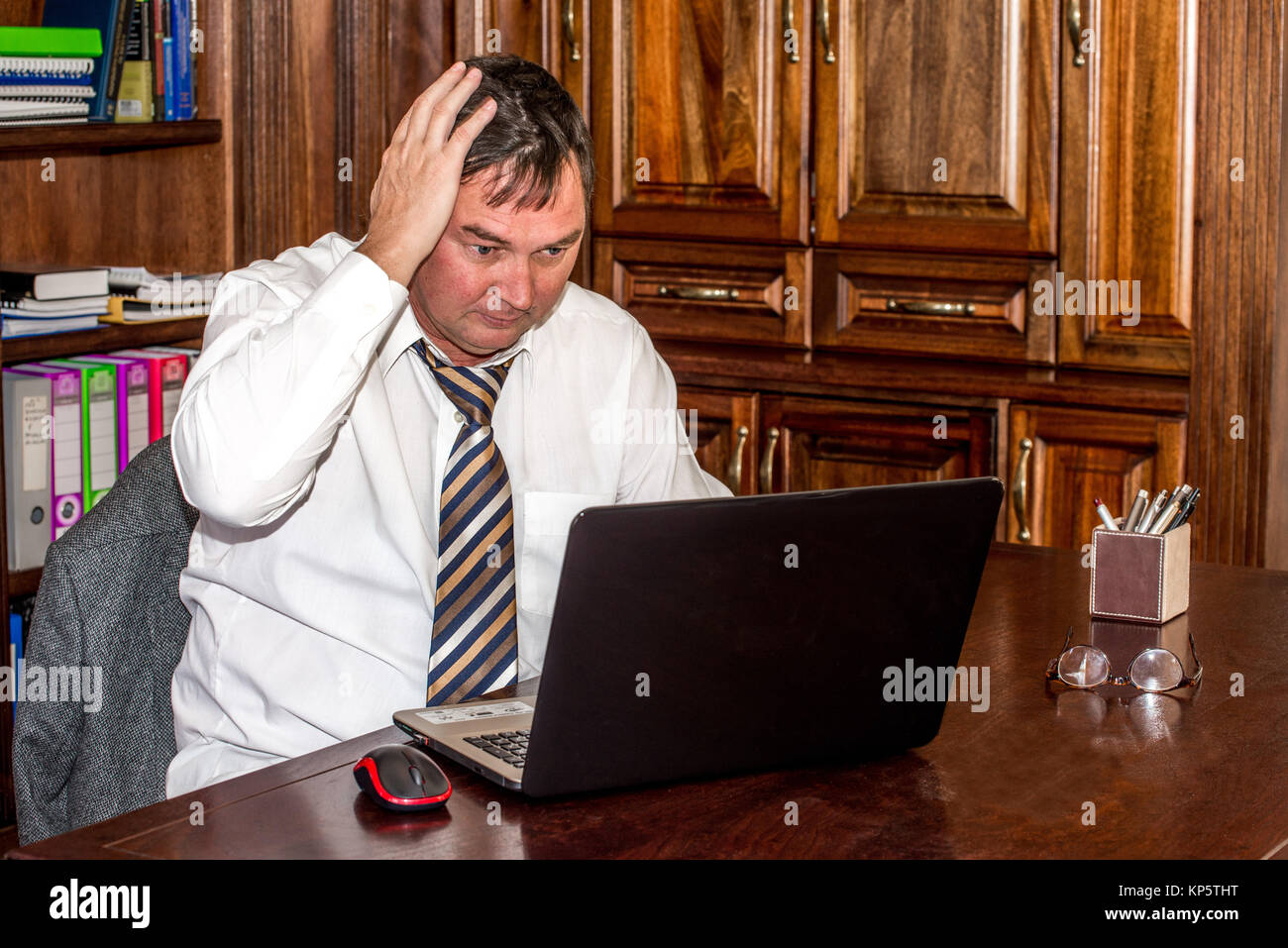 Stressed man with Laptop Stock Photo - Alamy