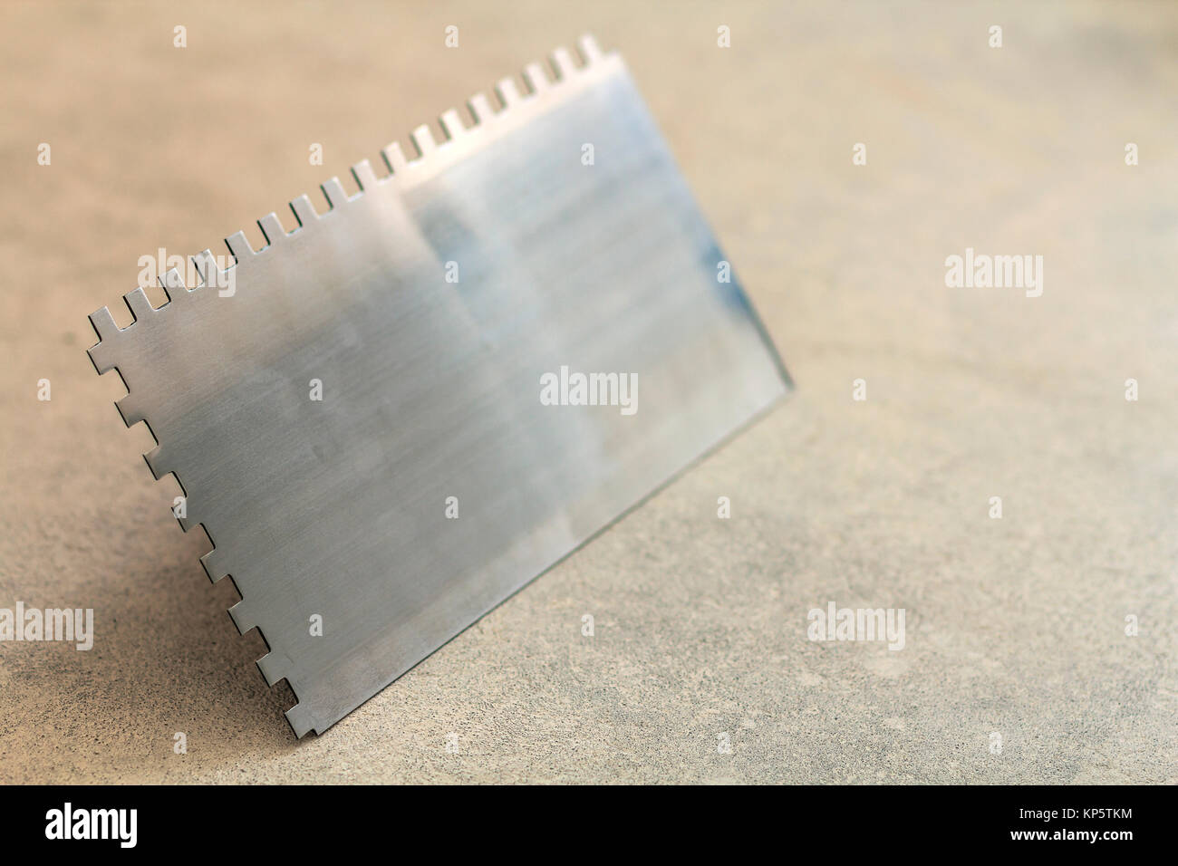 Construction notched trowel is a tool for tiles installation work Stock ...